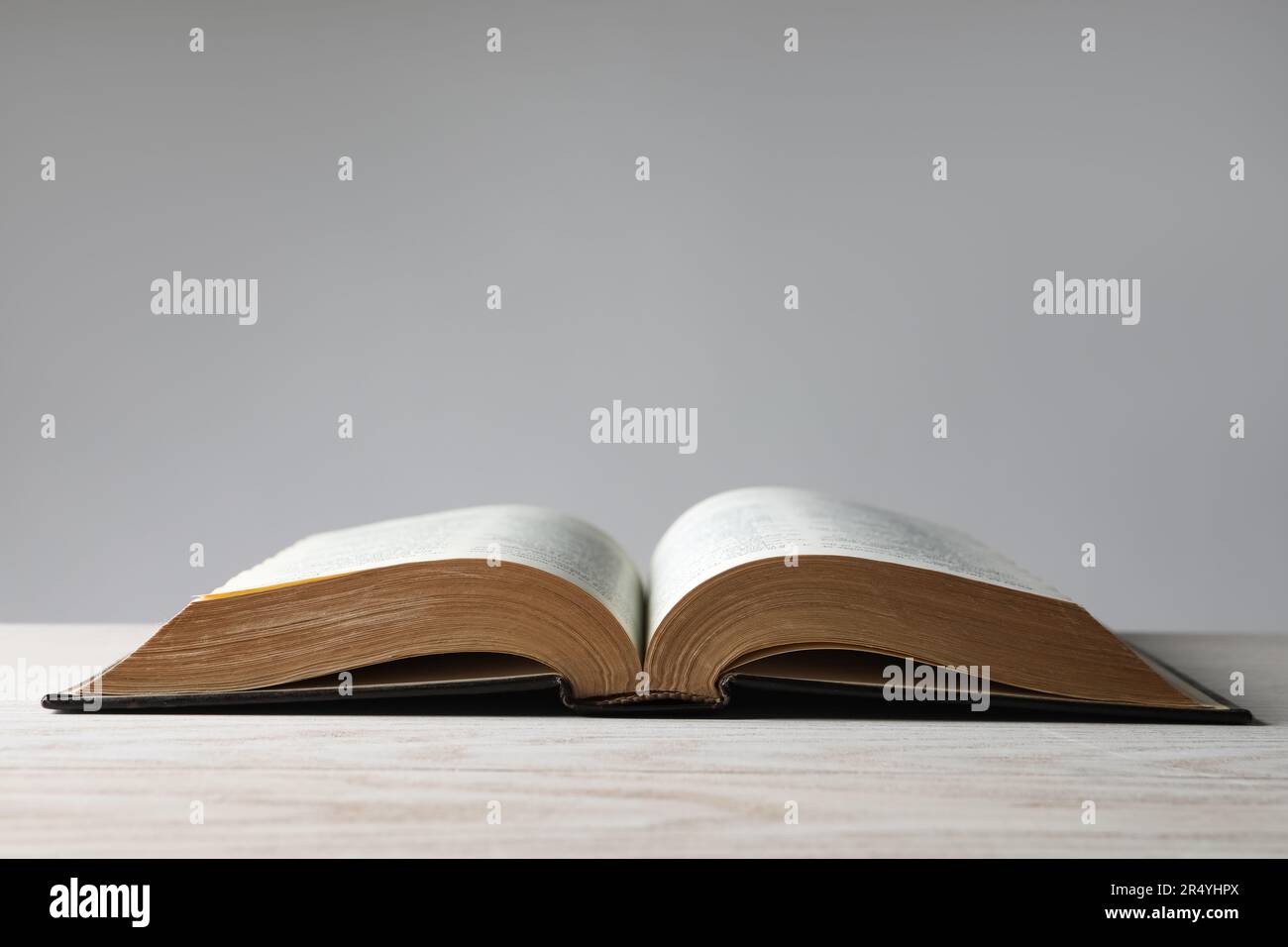 Open Bible on wooden table. Christian religious book Stock Photo - Alamy