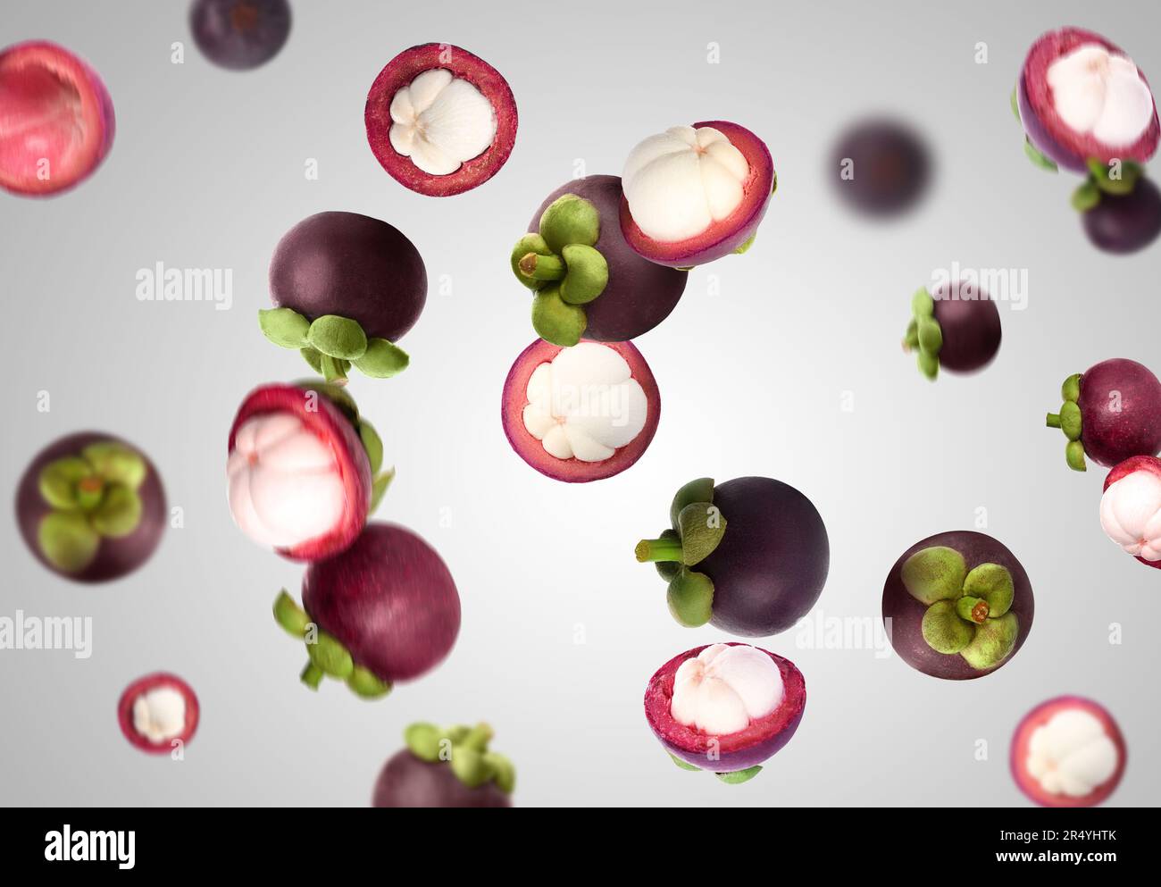 Many ripe mangosteen fruits falling on light grey background Stock ...