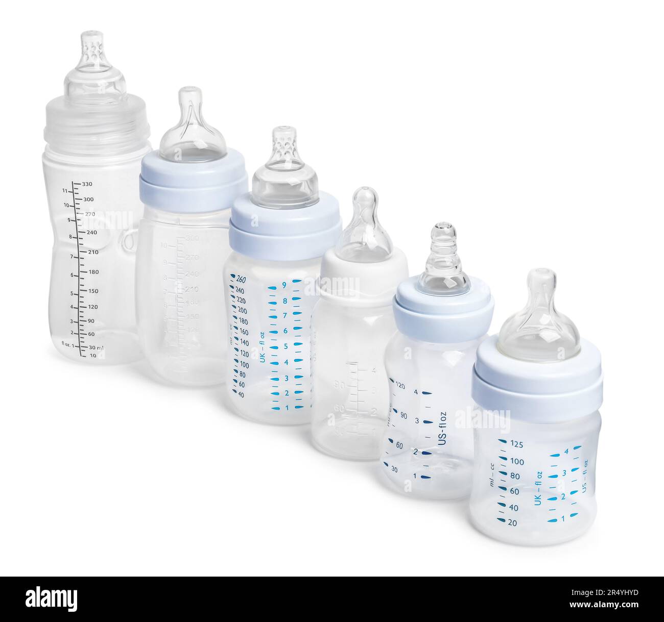 Many different empty feeding bottles for infant formula on white ...
