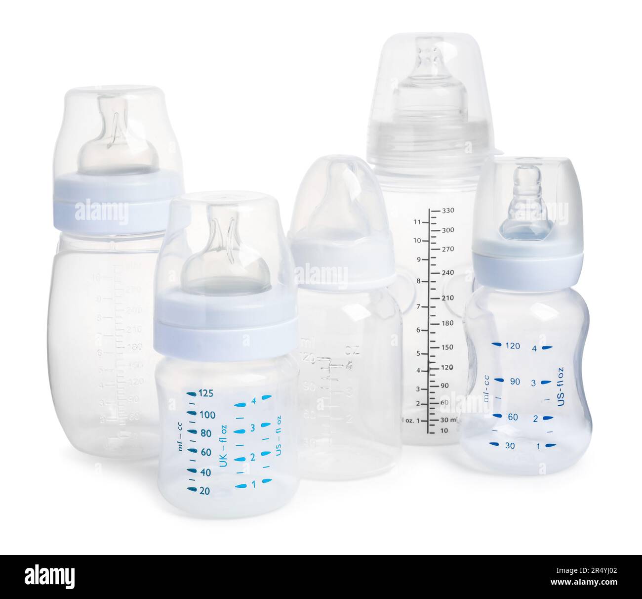 Many different empty feeding bottles for baby milk on white background ...