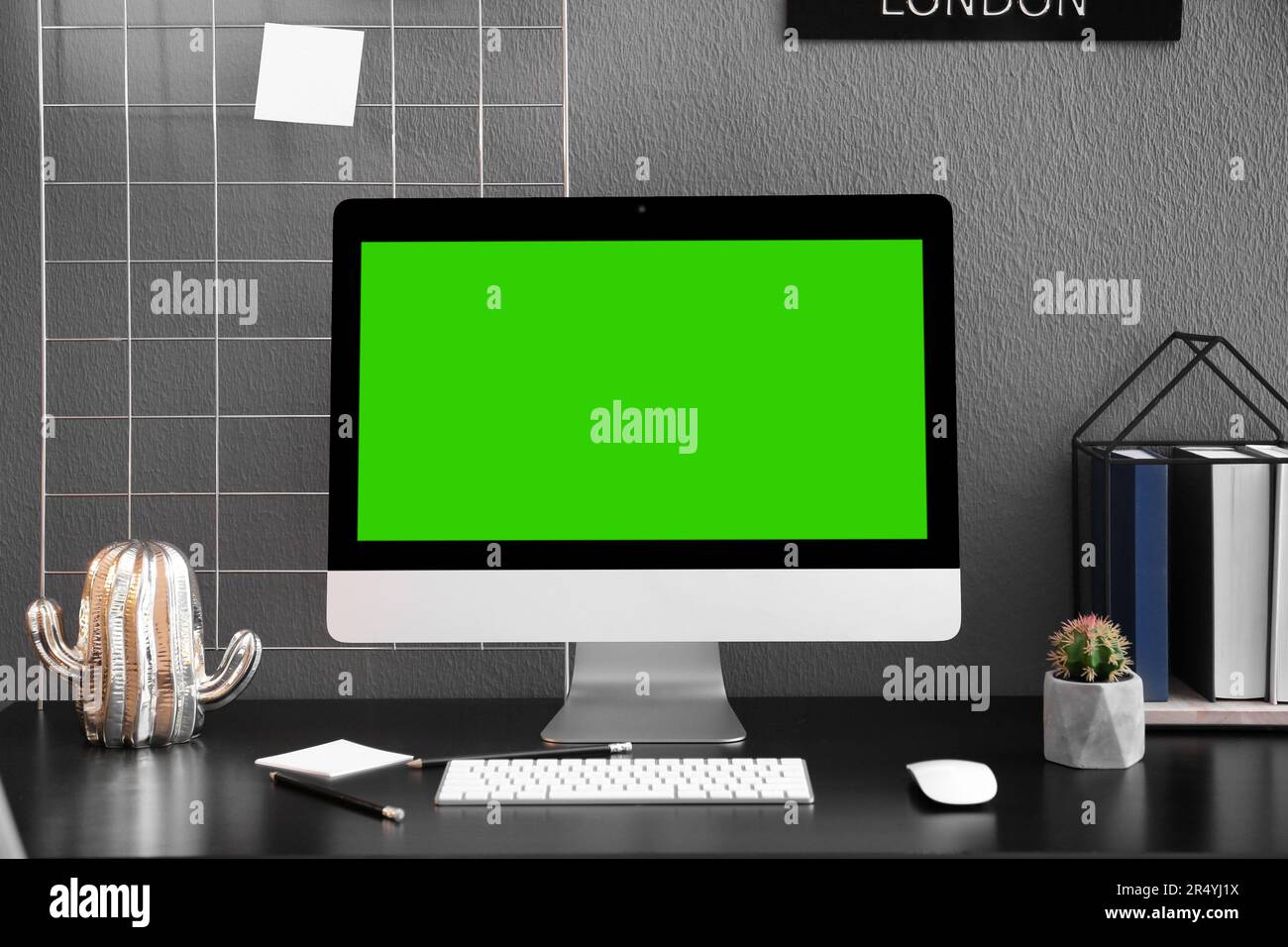 Computer display with chroma key on desk in room. Comfortable workplace ...