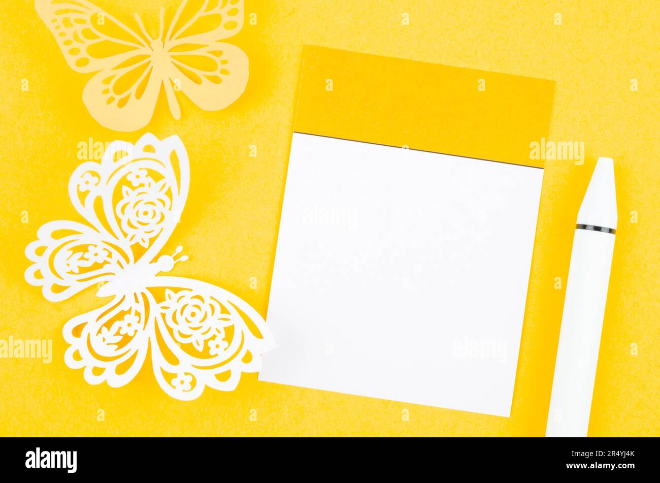 Blank paper note for reminder and carve of paper butterfly with the pen ...