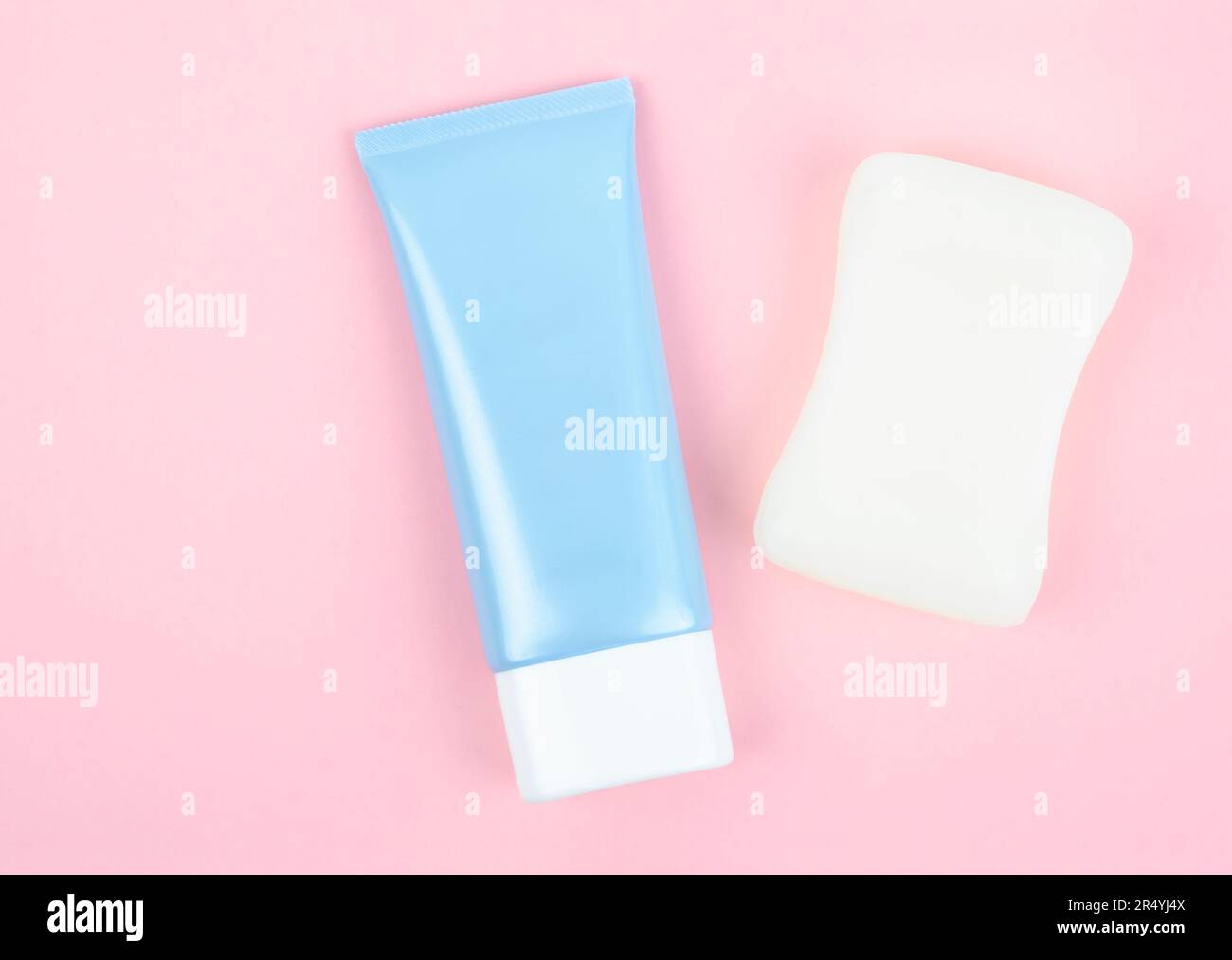 op view blue squeeze bottle plastic tube and herb soap bar on beautiful ...