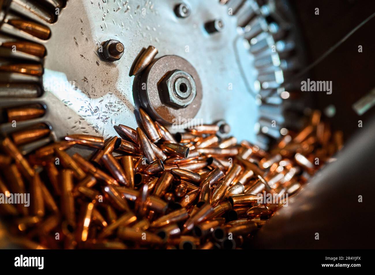 Pile of Copper bullet shells and turning wheel at production line Stock ...