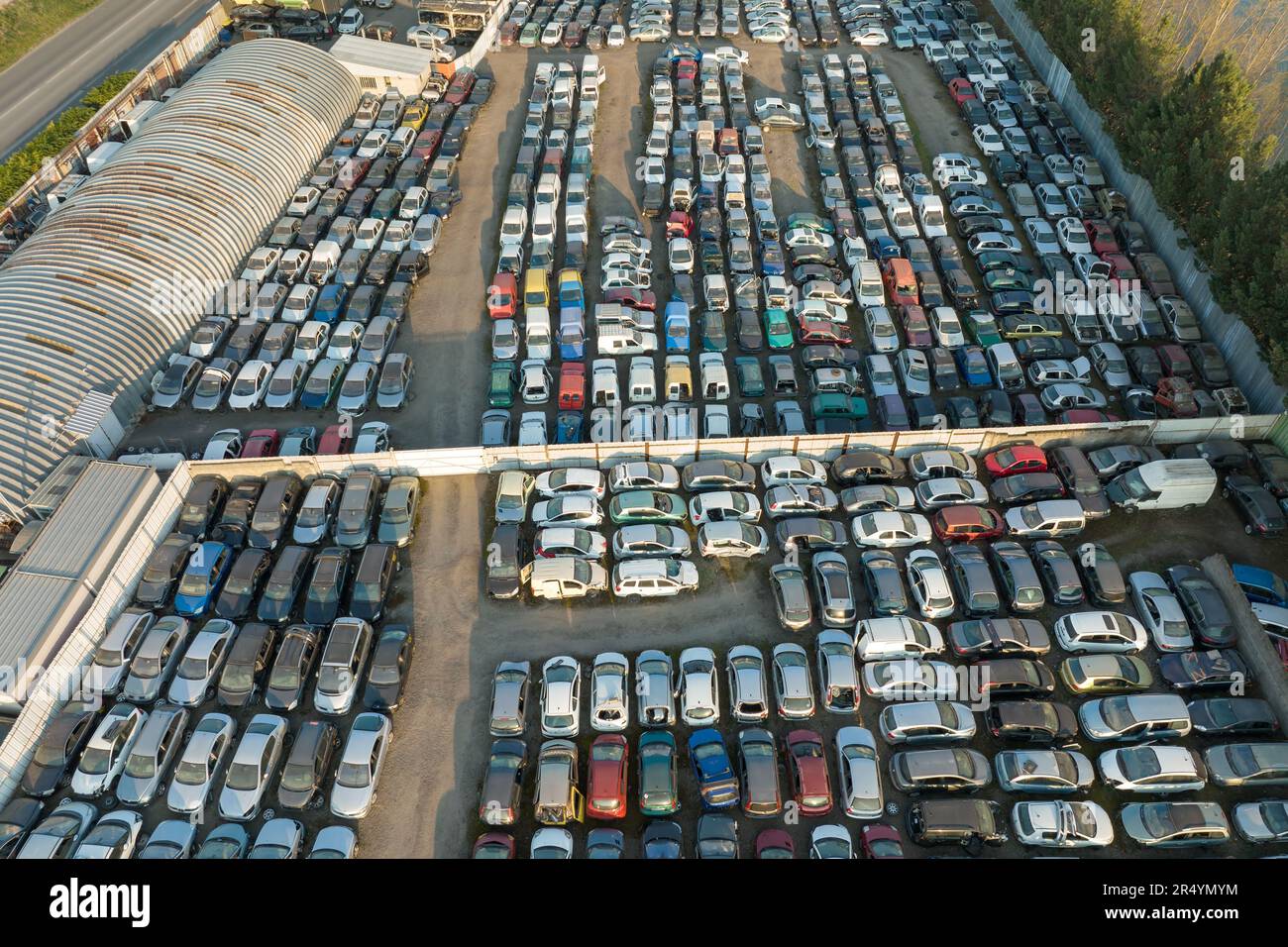 Aerial view of big parking lot of junkyard with rows of discarded ...