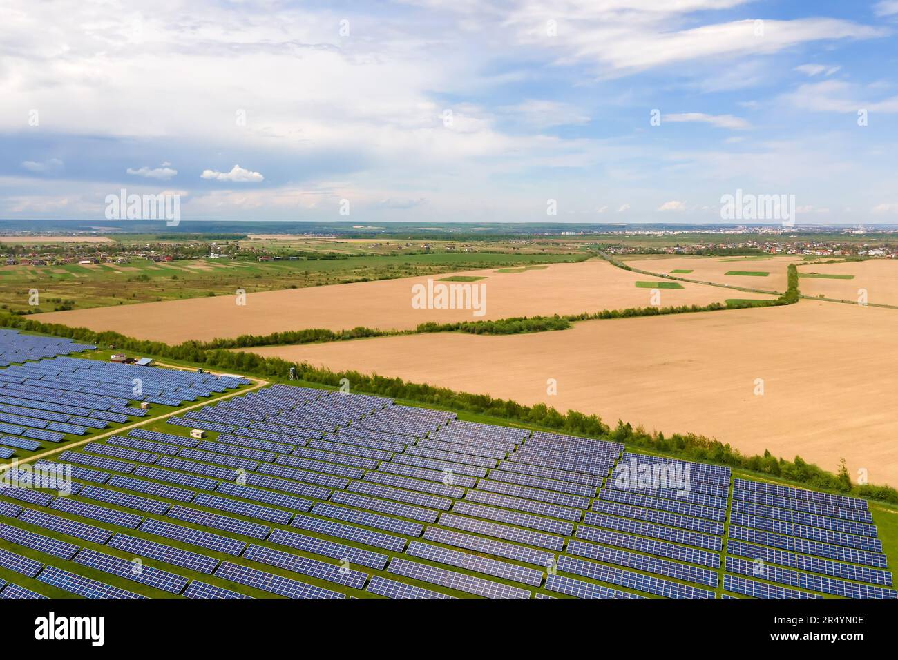 Aerial view of big sustainable electric power plant with many rows of ...