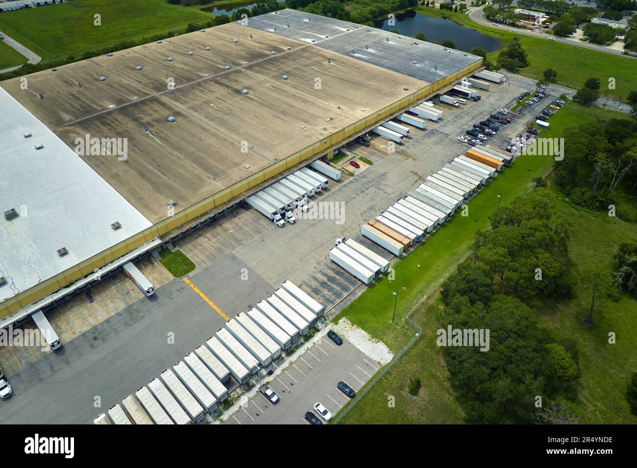 Aerial view of large commercial loading bay with many delivery trucks ...