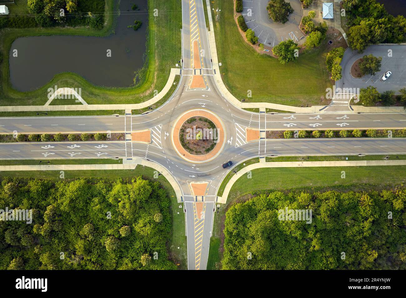 Aerial view of road roundabout intersection with moving cars traffic. Rural circular ...