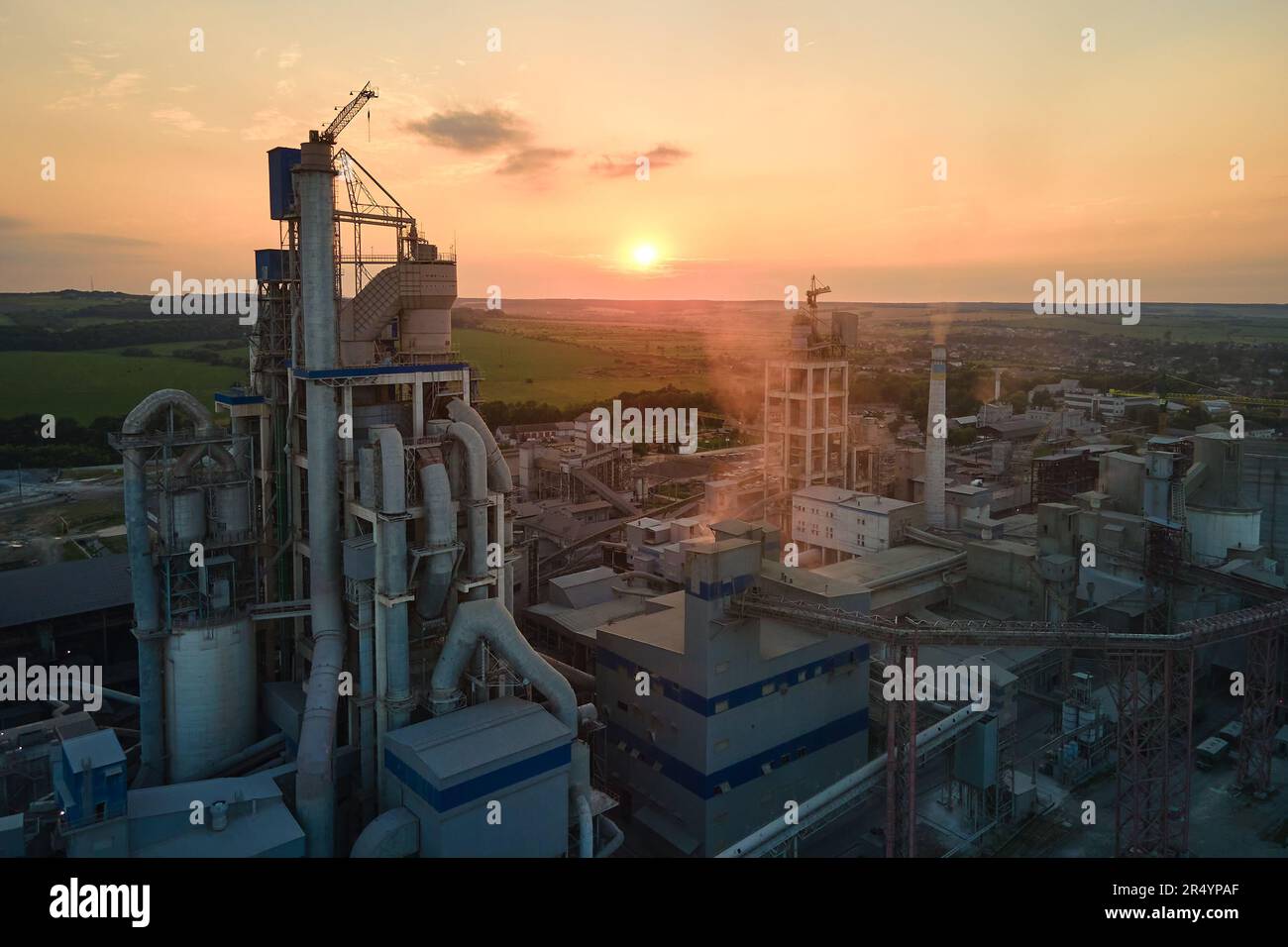 Cement plant with high factory structure and tower cranes at industrial ...