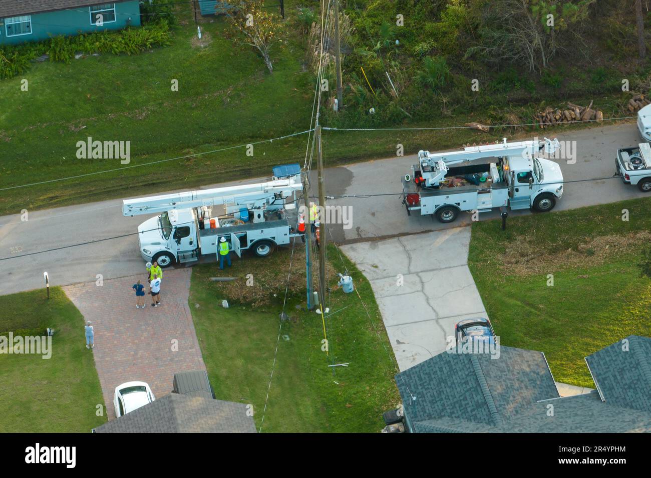 Electrical service company restoring power repairing damaged power ...