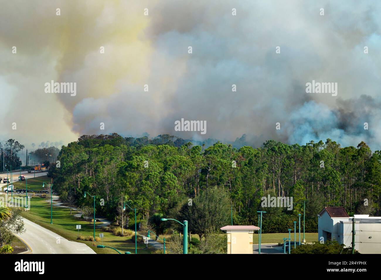Fire department firetrucks extinguishing wildfire burning severely in ...