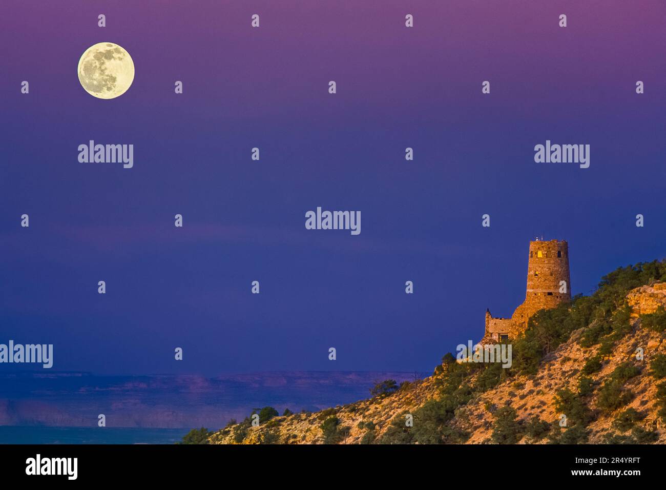 full moon over the watchtower at desert view above grand canyon ...