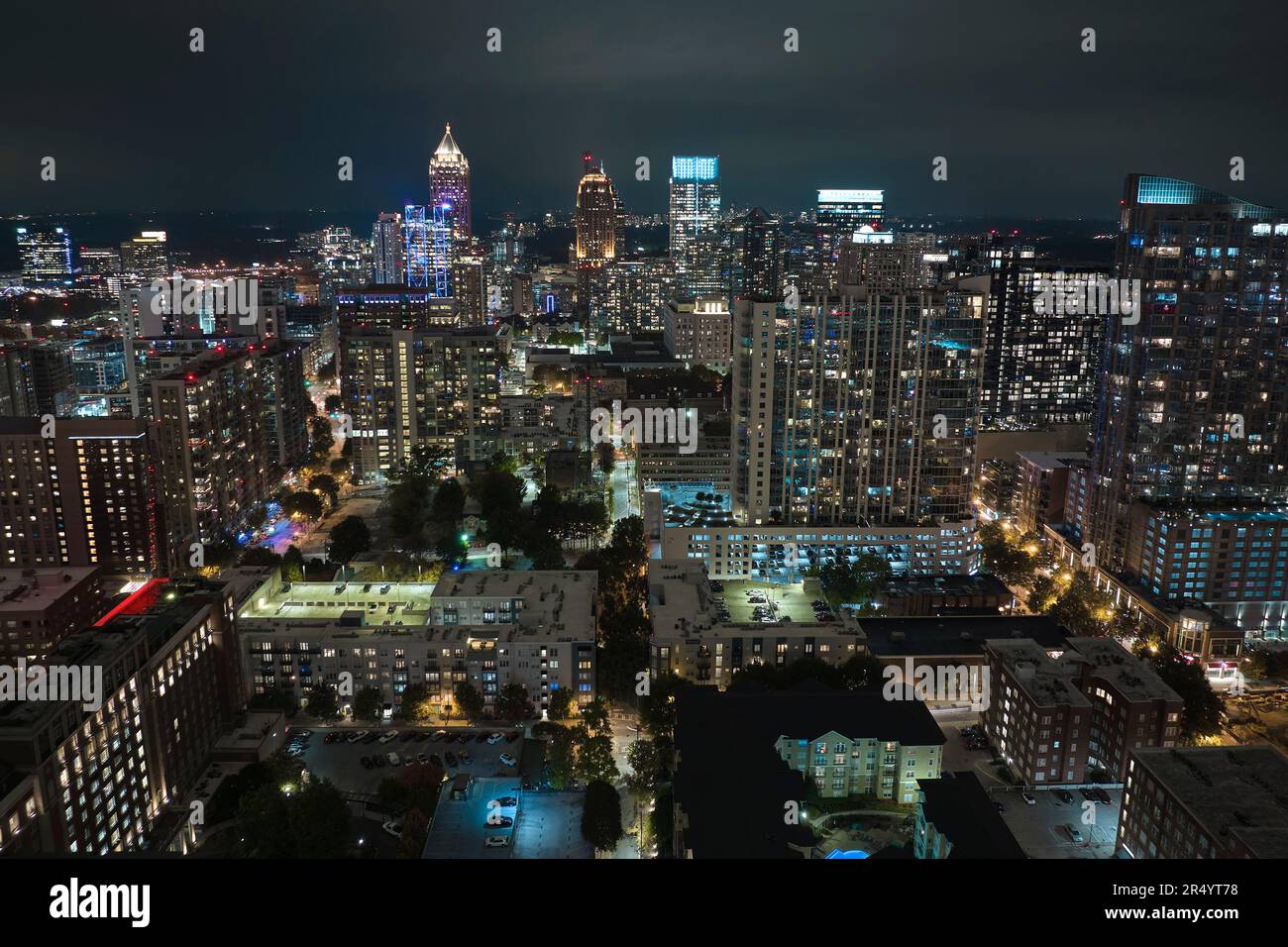 View from above of brightly illuminated high skyscraper buildings in ...