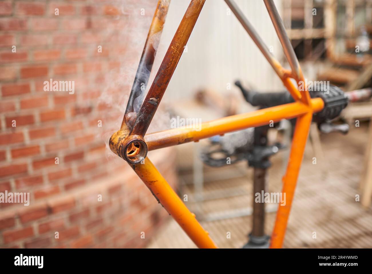 Manual bicycle renovation work, paint removal process using a torch ...