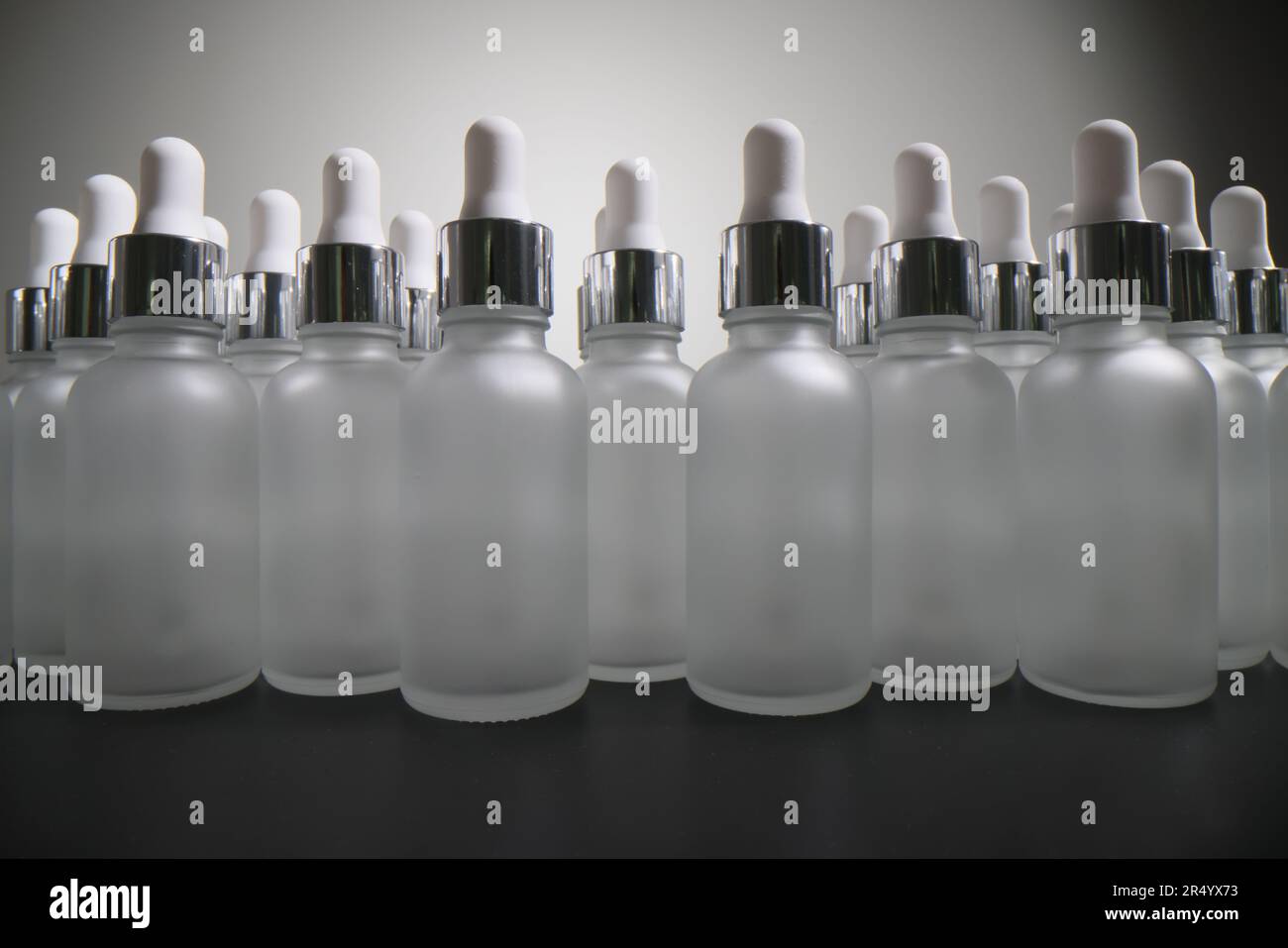 Glass bottles with pipettes for cosmetic products in lab Stock Photo ...