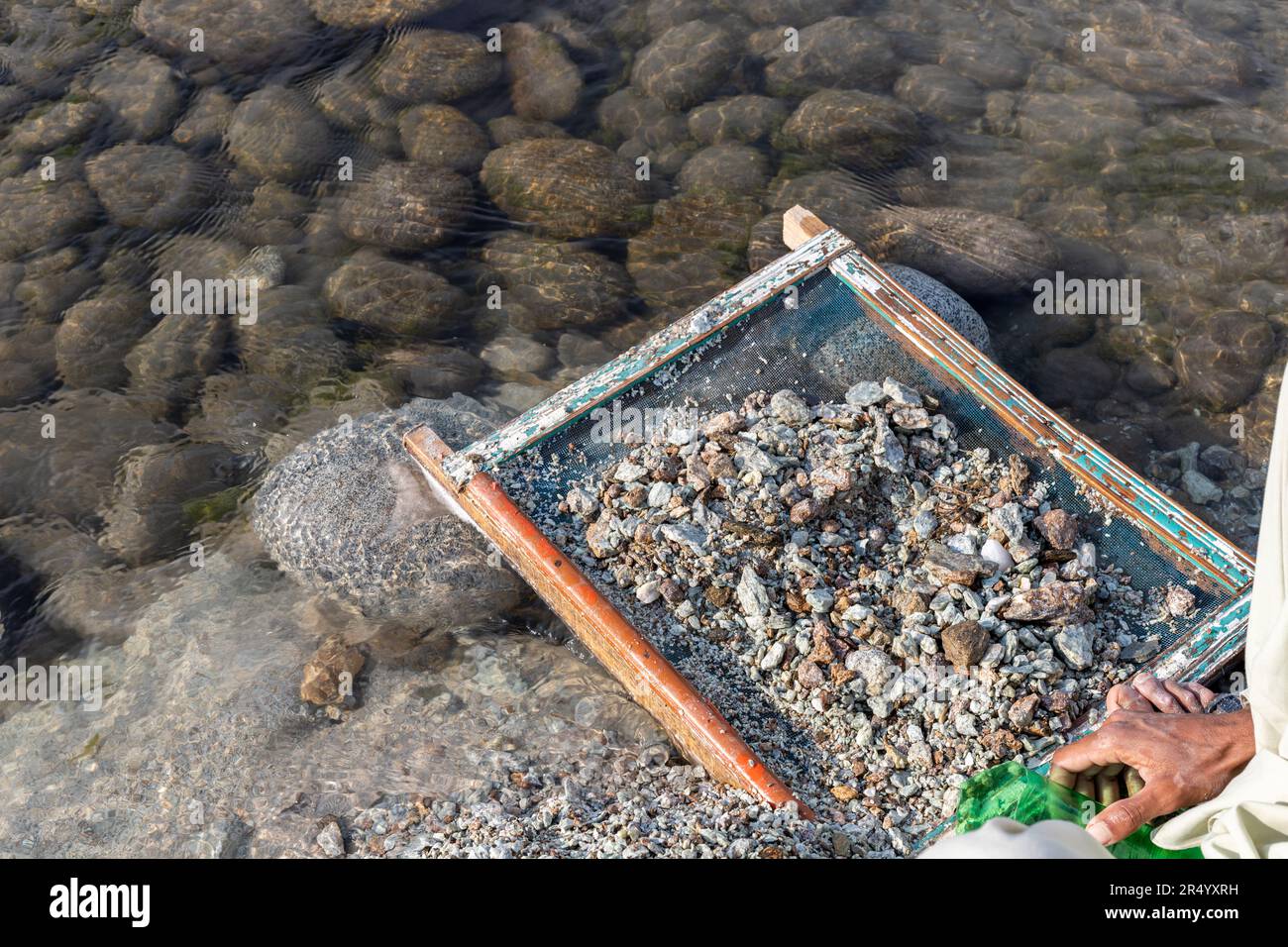 Searching for gemstones in the gravel near the extraction of mine ...