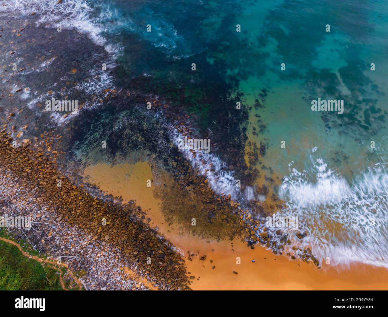 Sunrise over the sea and beach at Copacabana Beach on the Central Coast ...
