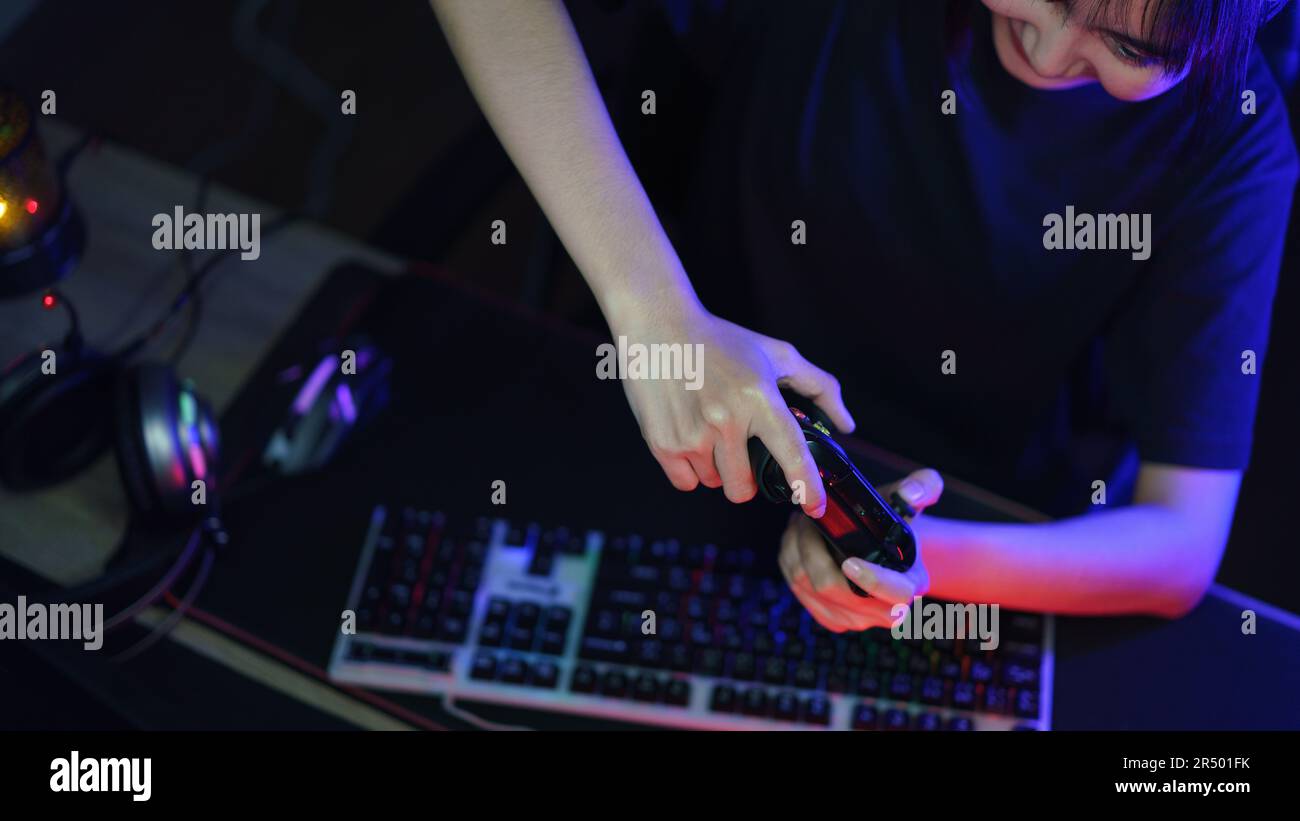 Female cyber hacker gamer playing or streaming video games on computer ...