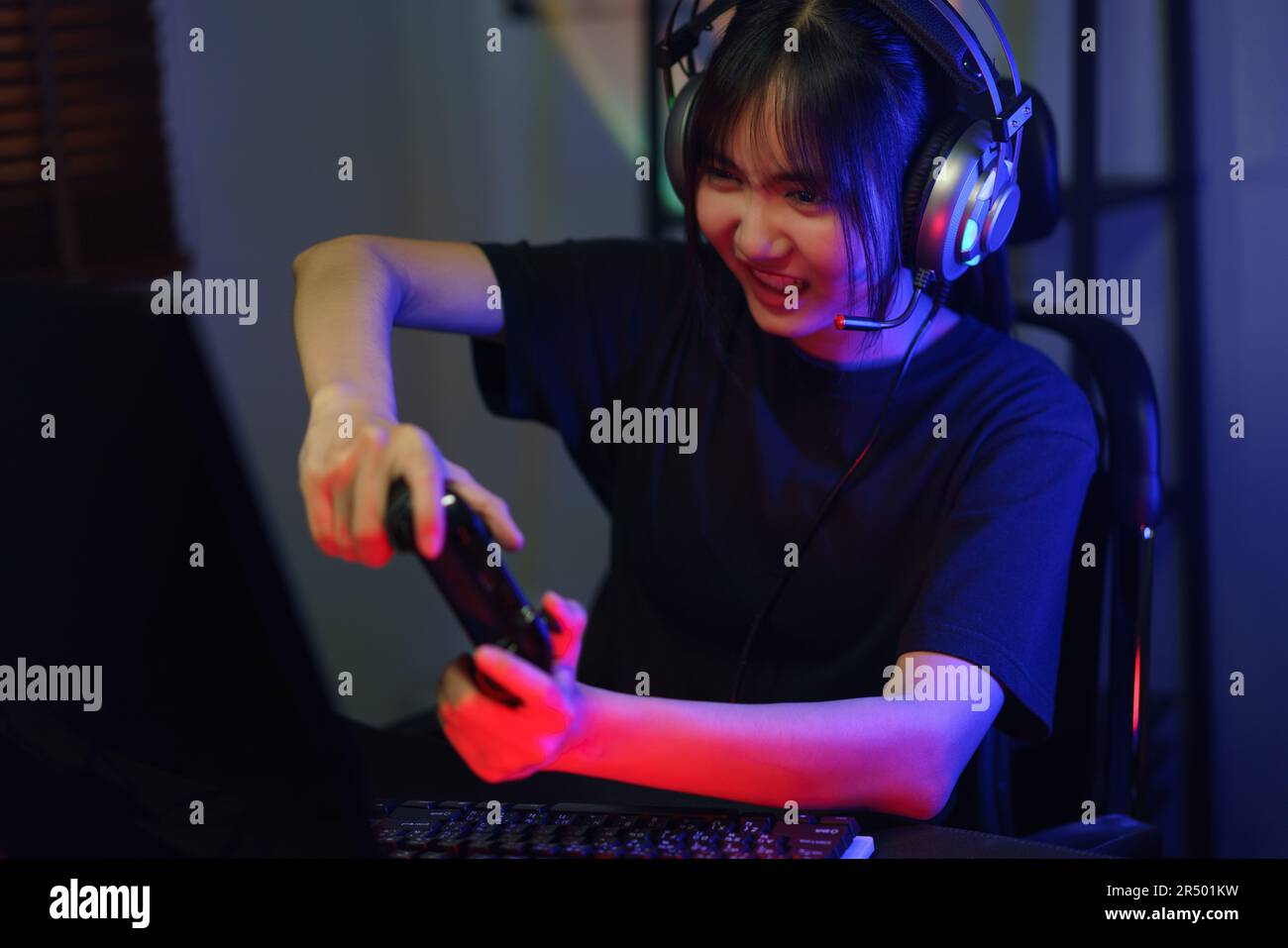 Female cyber hacker gamer in headphone playing video games on computer ...