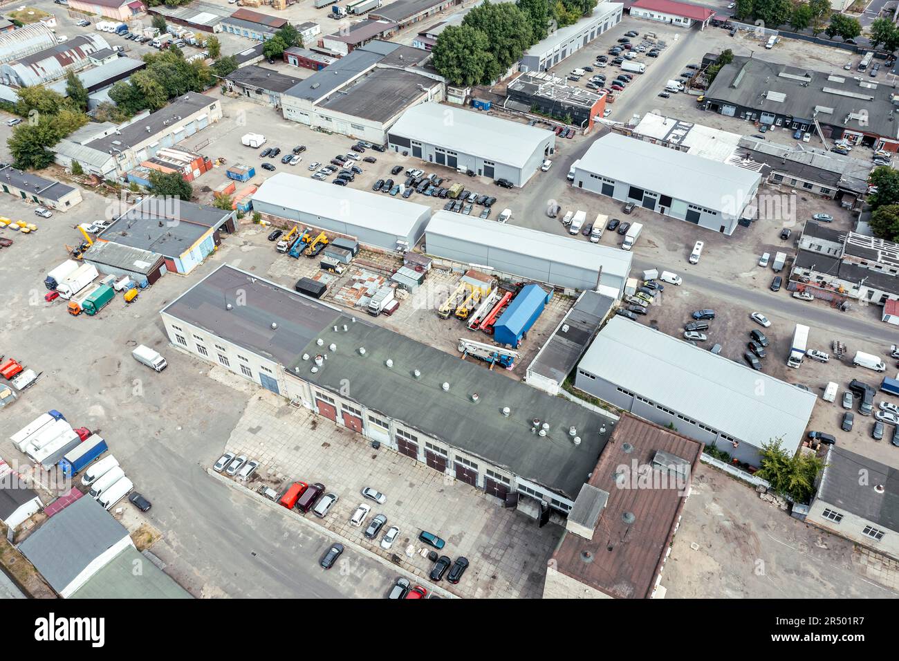 urban industrial area with warehouses, buildings, garage, trucks and ...