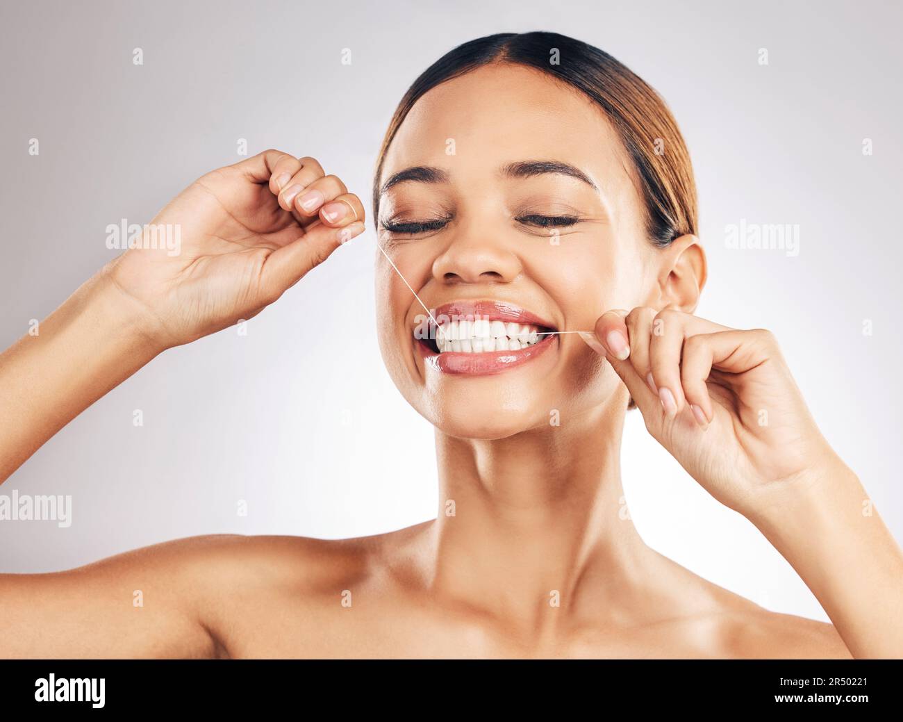 Smile, oral care and woman flossing teeth in studio for hygiene ...