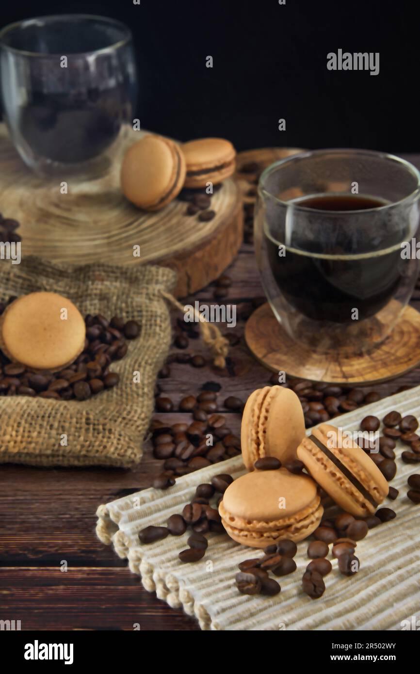 Coffee flavor macarons with coffee beans and cups of coffee Stock Photo ...