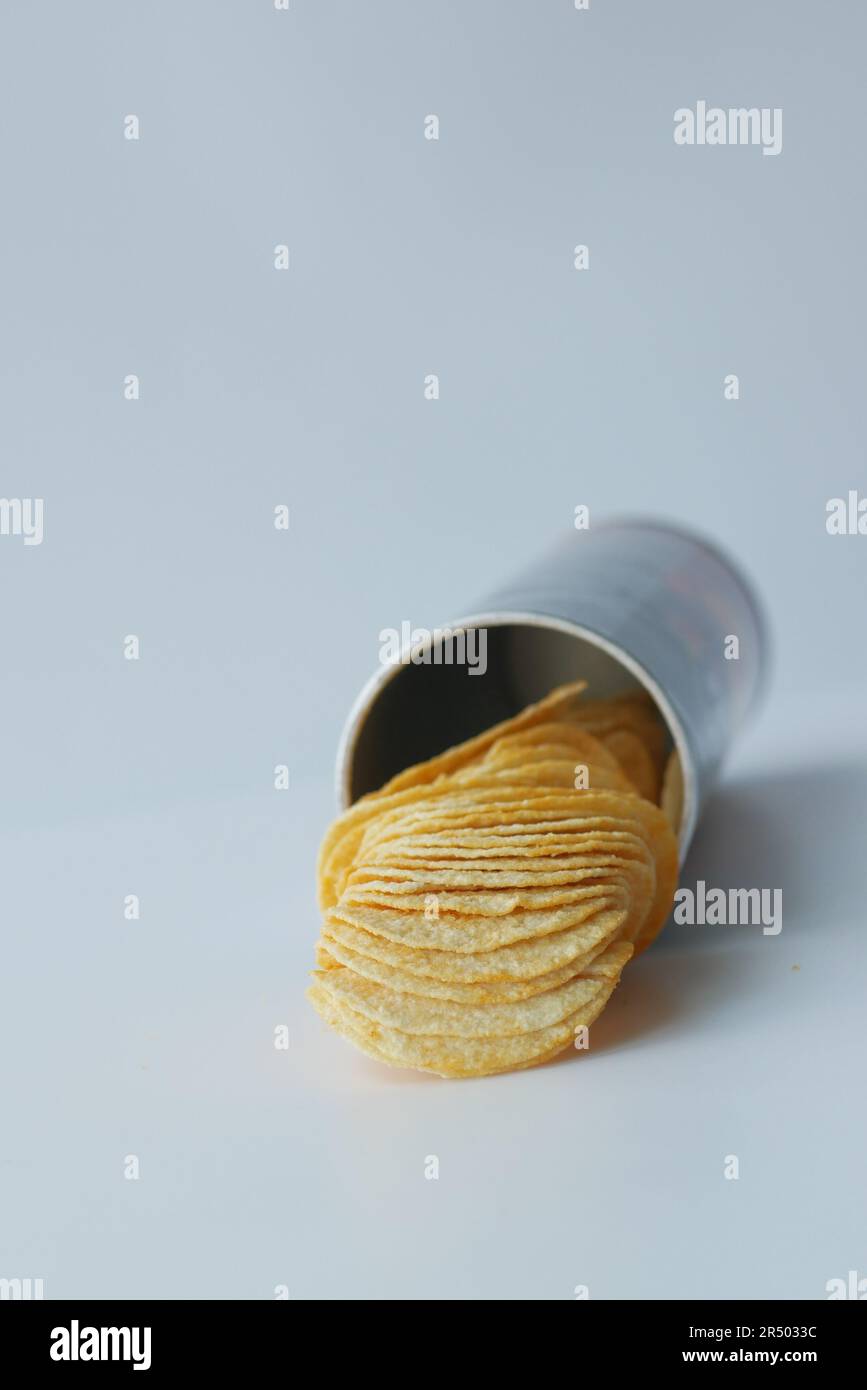 potato chips spilling form a packet on table Stock Photo - Alamy