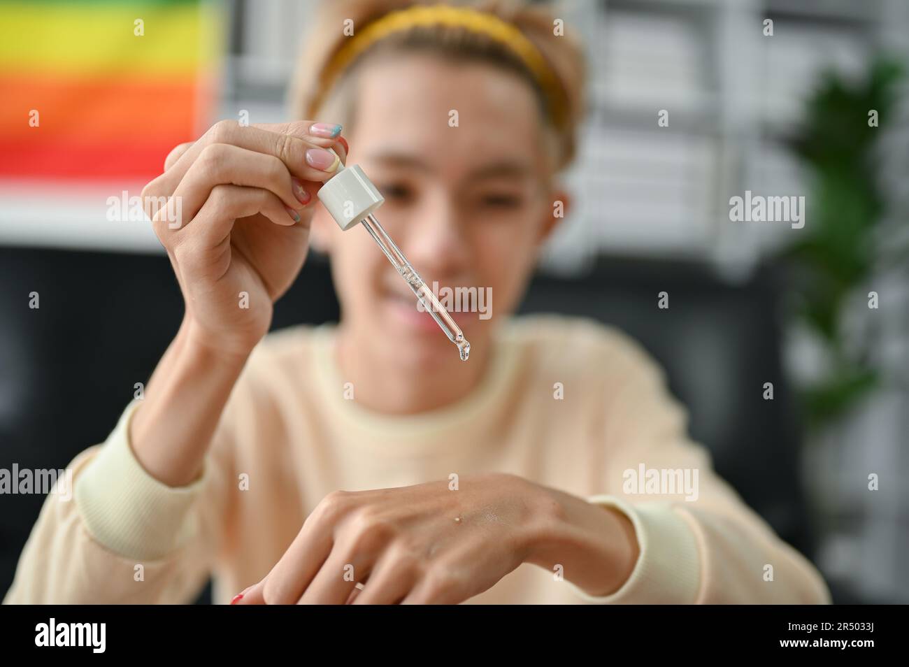 Close-up image of an attractive young Asian gay man dropping facial ...