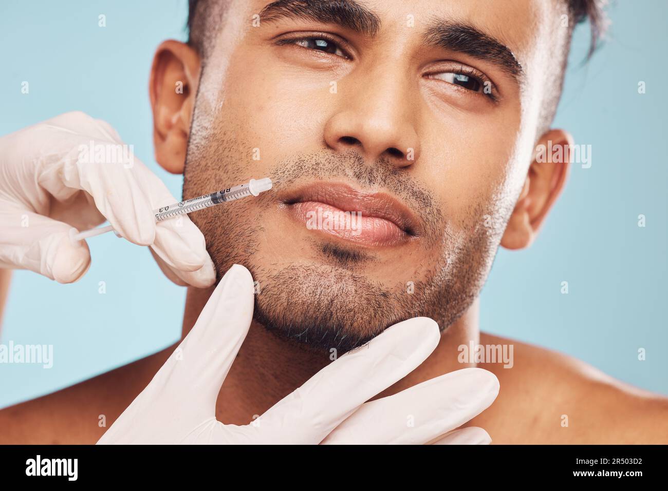 Beauty, botox and mouth with a man in studio on a gray background for a ...