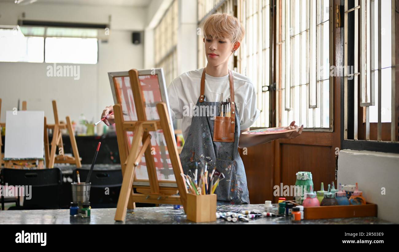 An attractive and talented young Asian gay man artist focuses on ...