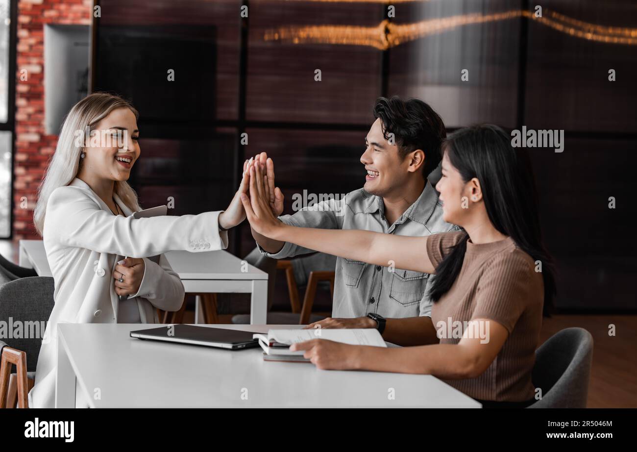 College students join study groups in the academic library to work on ...