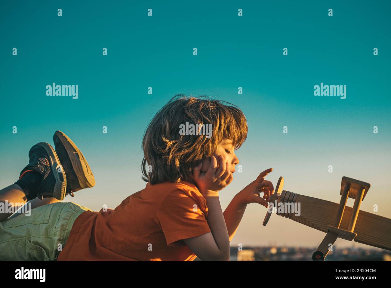 Little boy with toy wooden plane, boy wants to become pilot. Kid dreams of future. Kid pilot ...