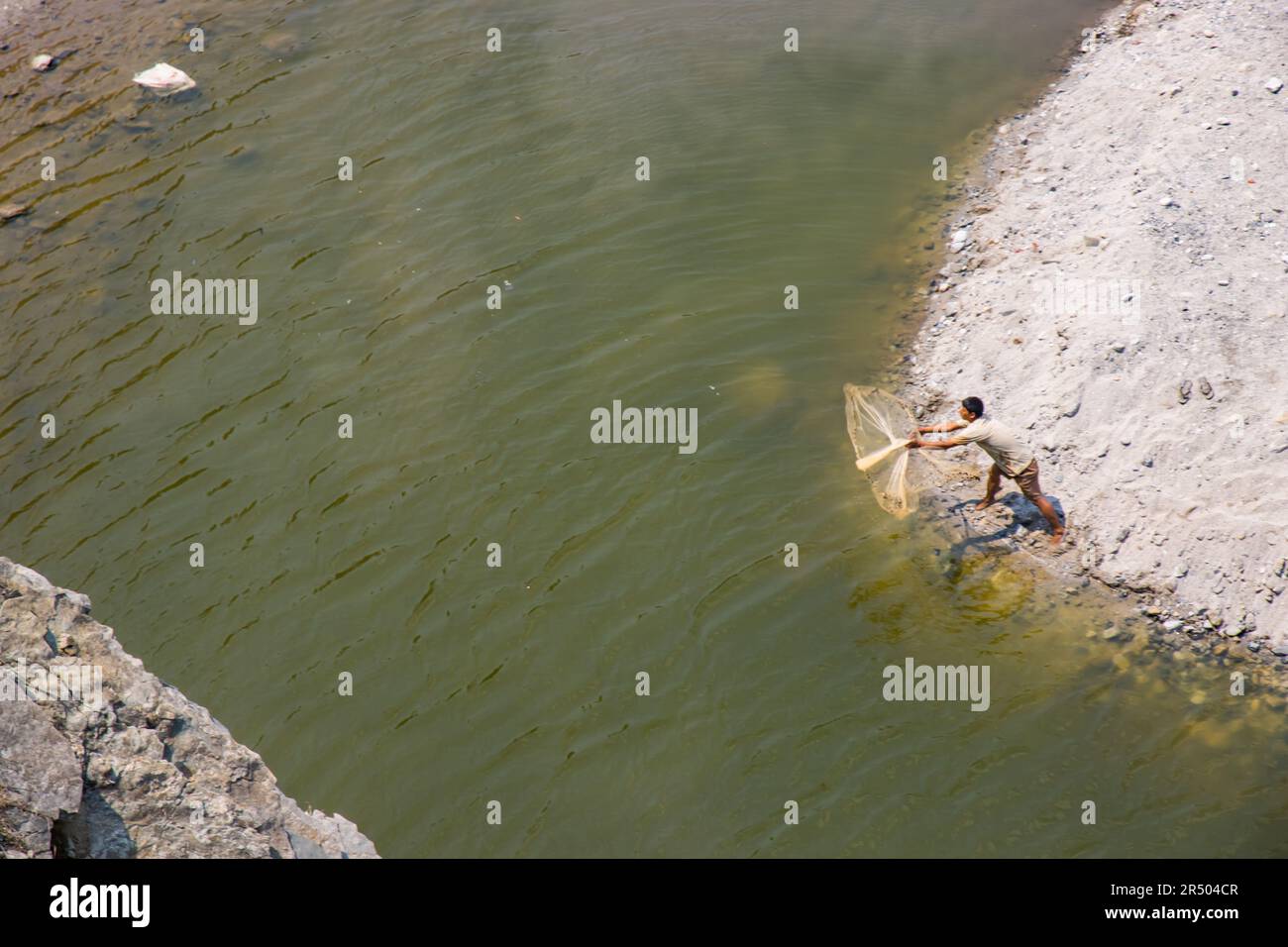 Traditional Fishing Fisherman Throwing Net on River to catch fish in ...