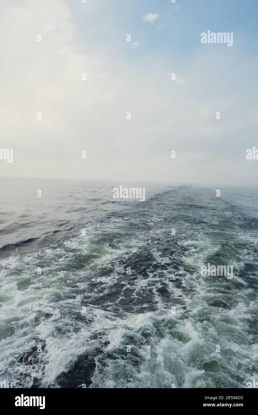 Wake of vessel. Wide wake trail from boat. Ocean water. Deep blue ...