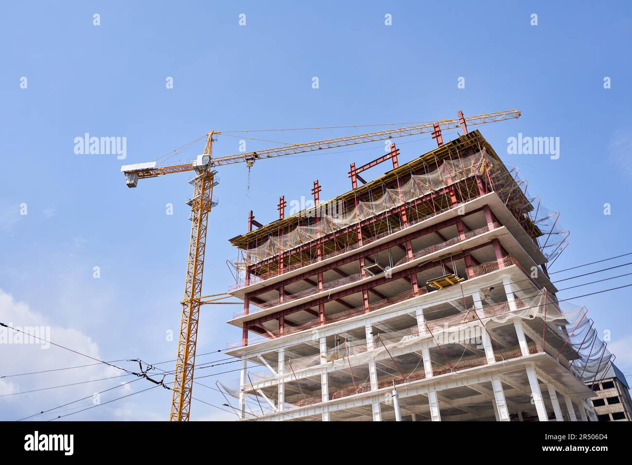 Hydraulic luffing jib tower cranes and workers being poured concrete ...