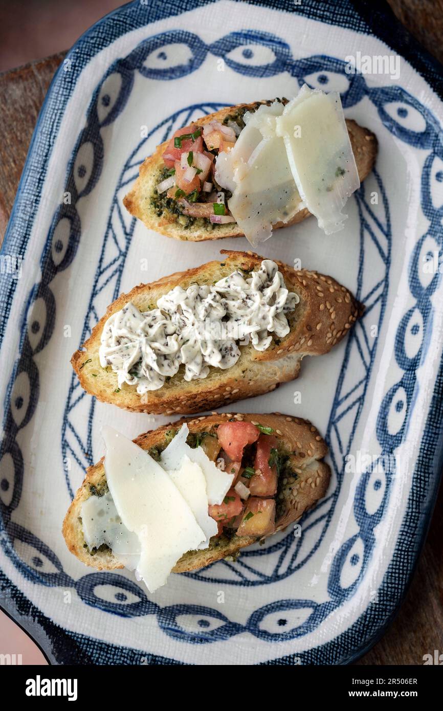 tapas with Bruschetta and creamed herb cheese on toast in rustic ...