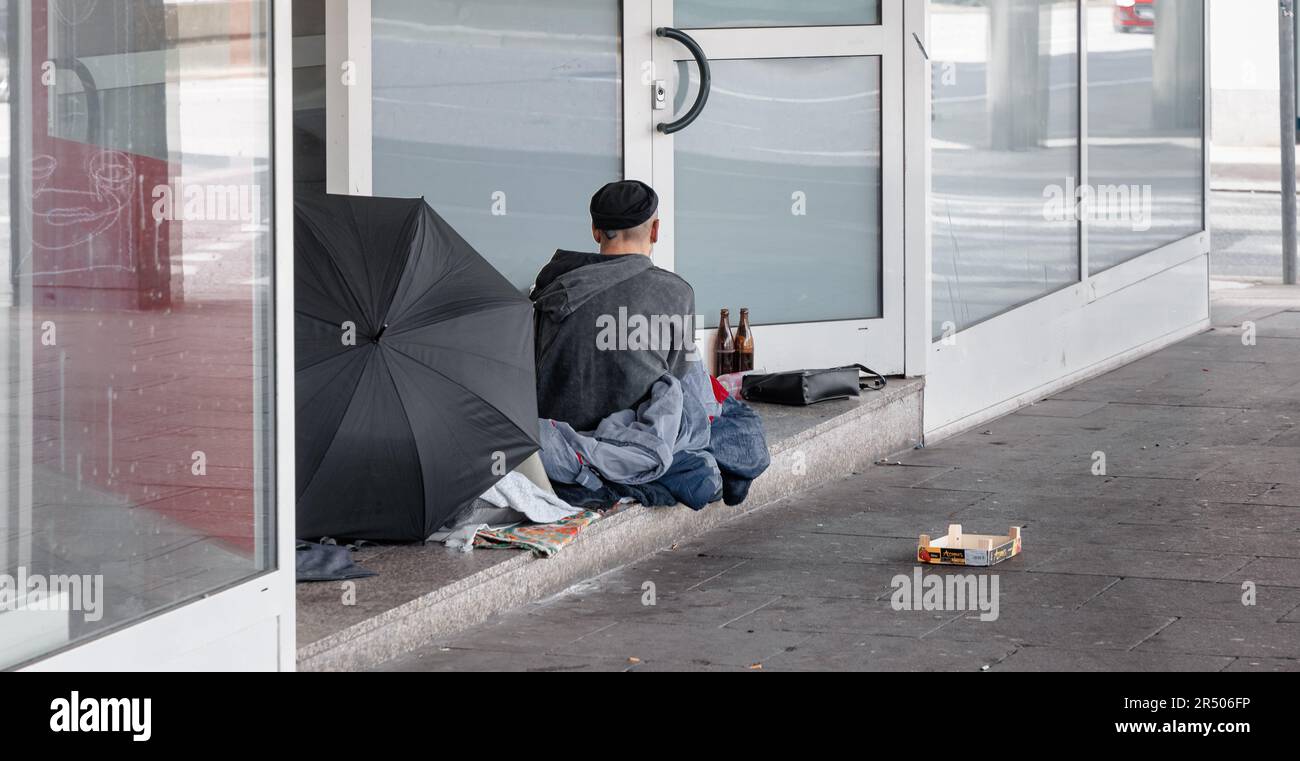 Hamburg, Germany. 21st May, 2023. A homeless man sits in his sleeping ...