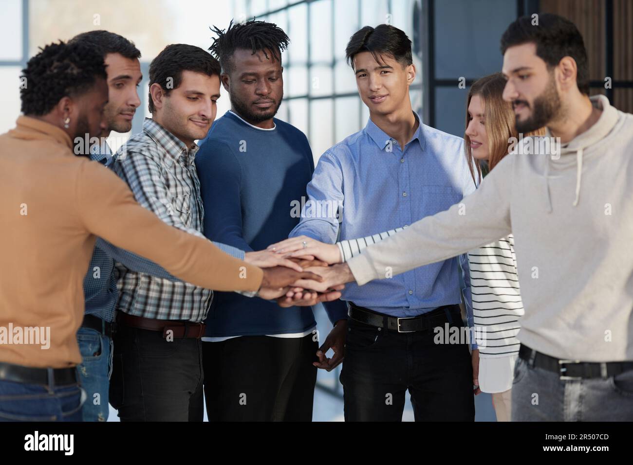 Happy colleagues welcome businessman to their successful team Stock ...