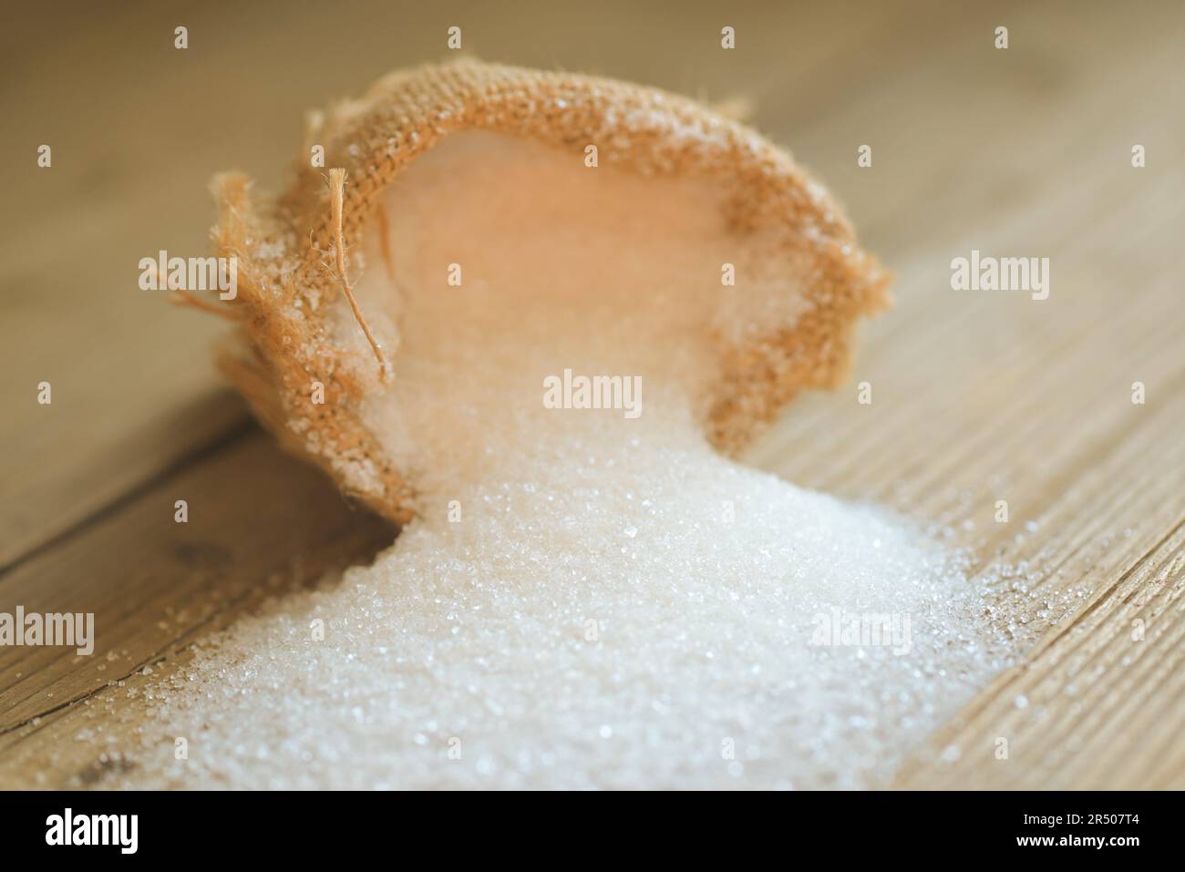 Sugar on sack and wooden background, white sugar for food and sweets ...
