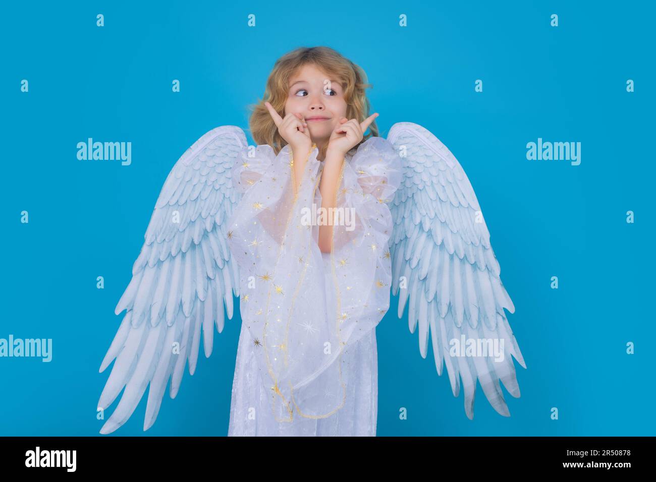 Child angel. Portrait of cute kid with angel wings isolated on studio ...