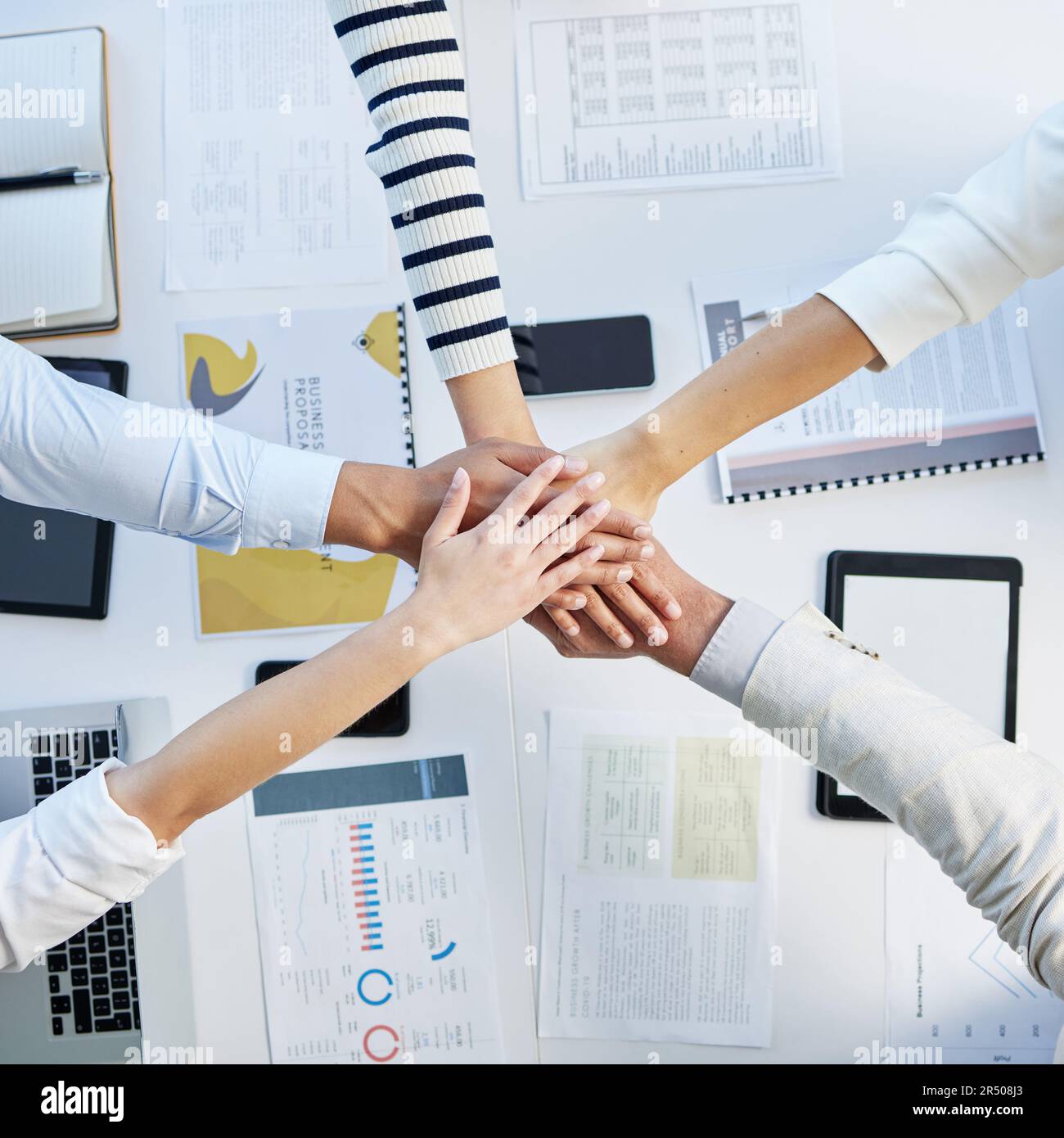 Top view, hands stack and table in office for motivation, team building ...