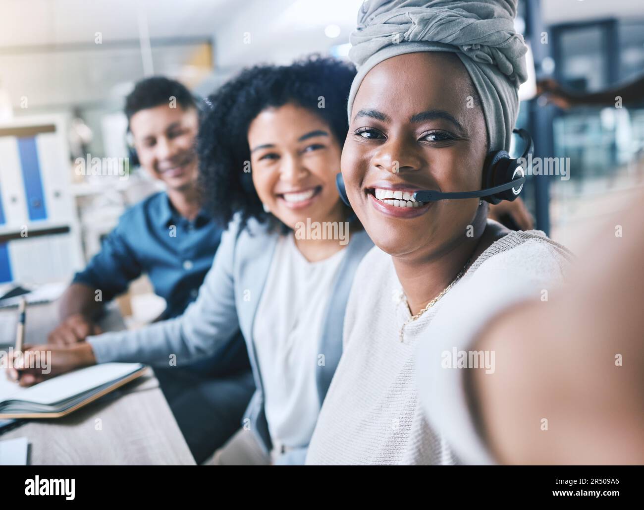 Diversity, portrait of colleagues with headset and taking a selfie ...