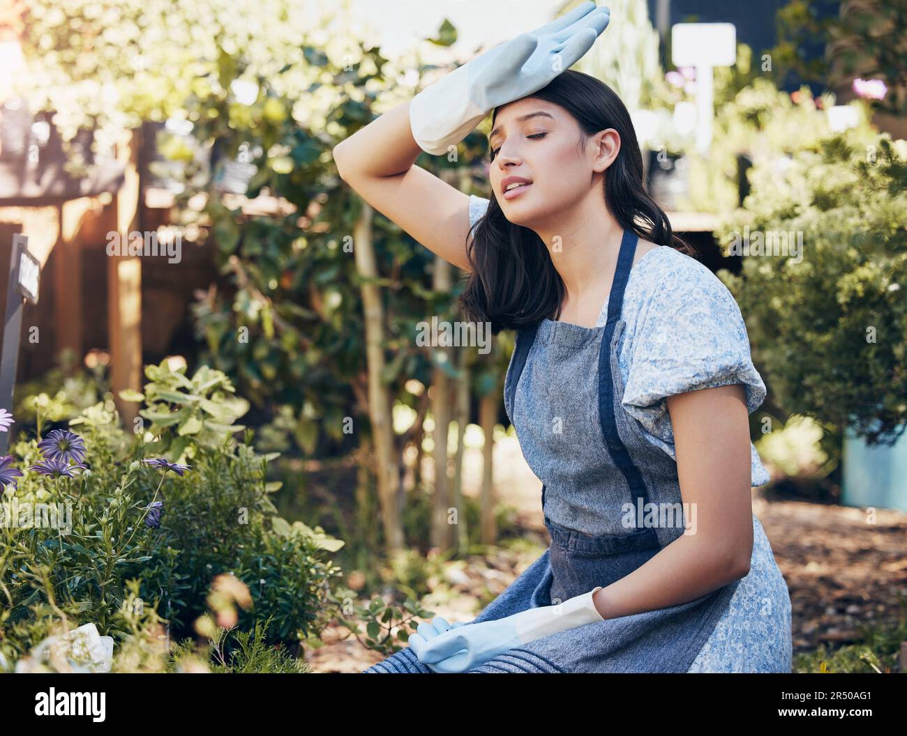 Florist, tired and woman working in garden, fatigue and exhausted outdoor at work. Plants ...