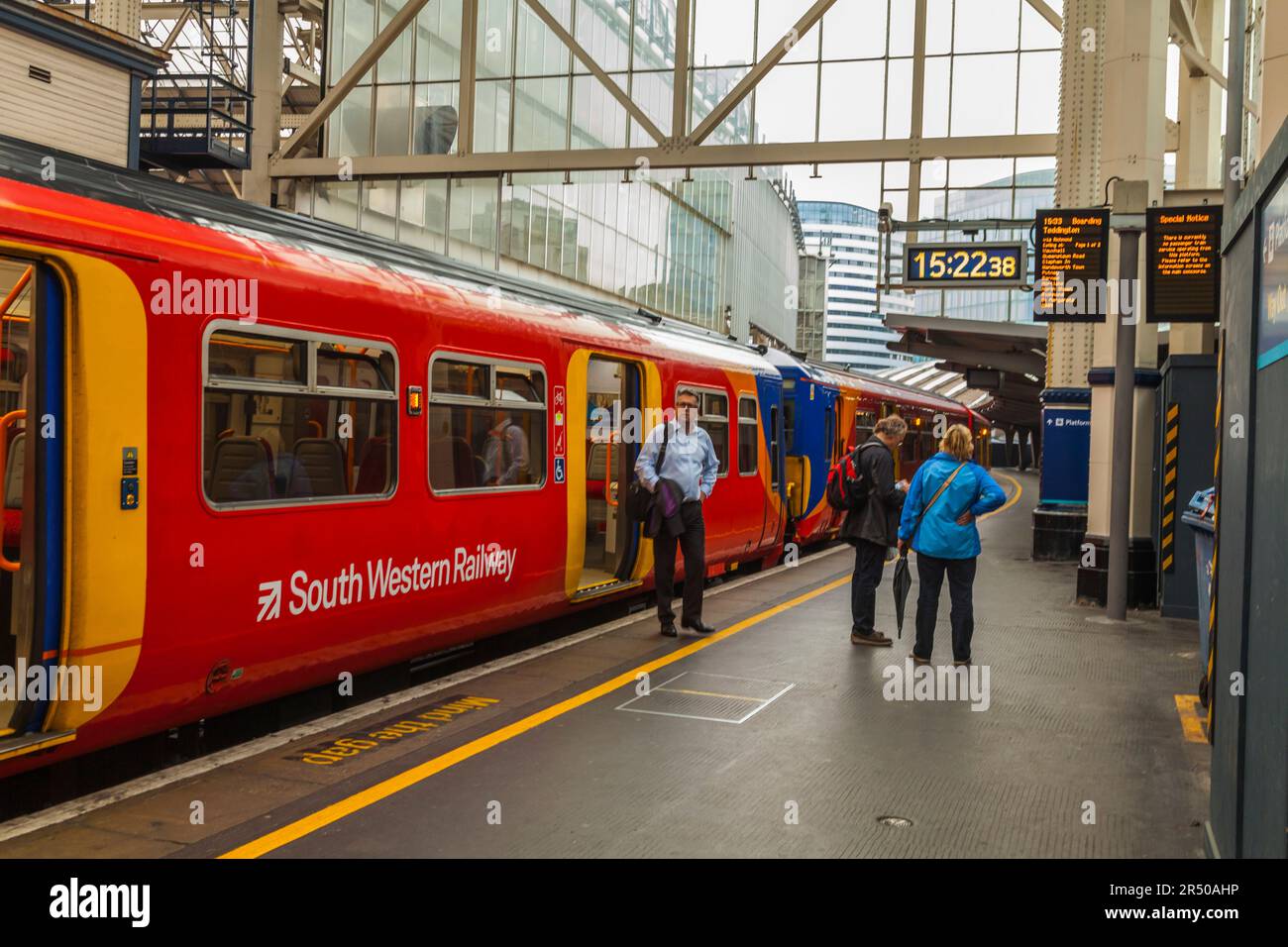 People checking the timetable at Waterloo Railway Station,London ...