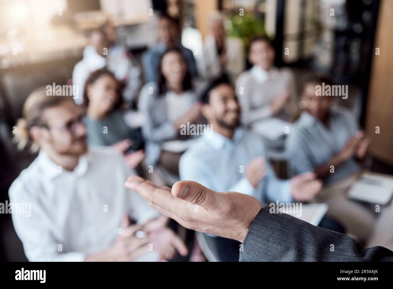 Speaker, hand and talking in business training presentation, seminar or speaking to professional ...