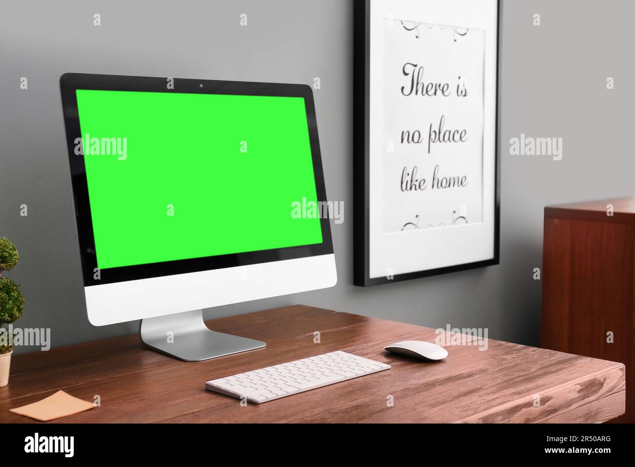 Computer display with chroma key on desk in room. Comfortable workplace ...