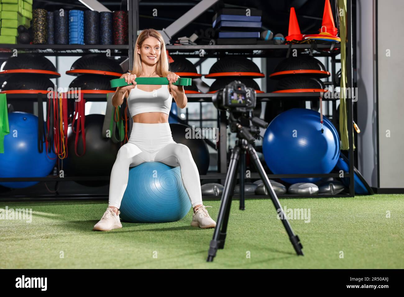 Fitness trainer recording online classes in gym Stock Photo - Alamy