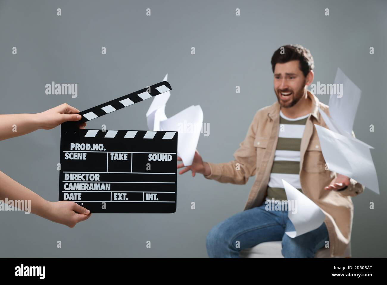 Emotional actor performing while second assistant camera holding ...