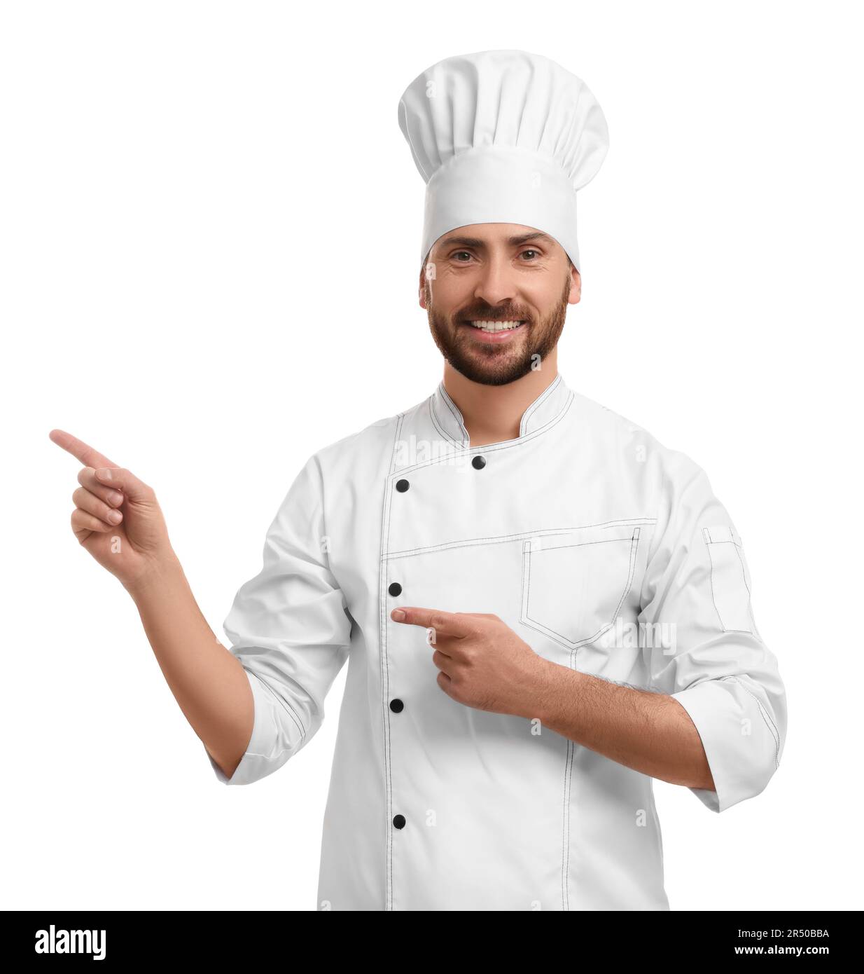 Smiling mature male chef pointing at something on white background ...