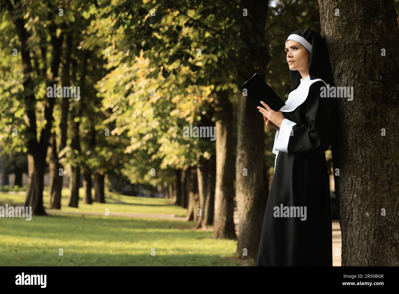 Person reading bible in park hi-res stock photography and images - Alamy